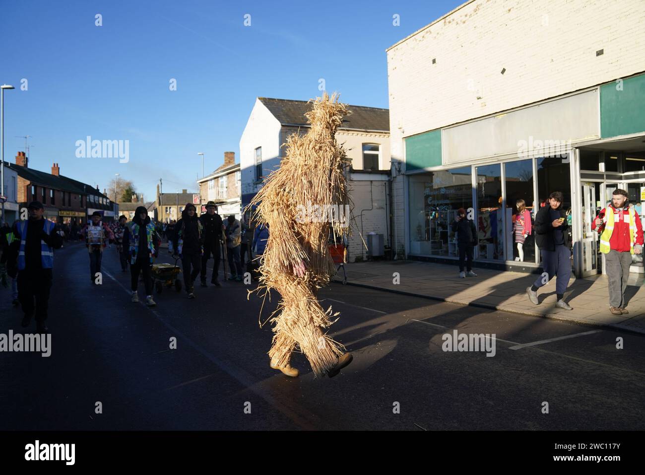 The Straw Bear is paraded through the streets accompanied by attendant ...