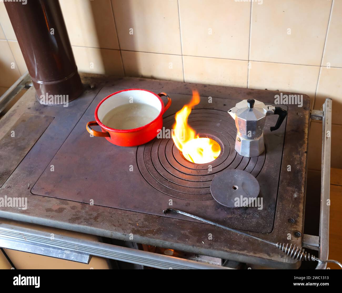 old wood stove in the house in the mountains and the fire lit while ...