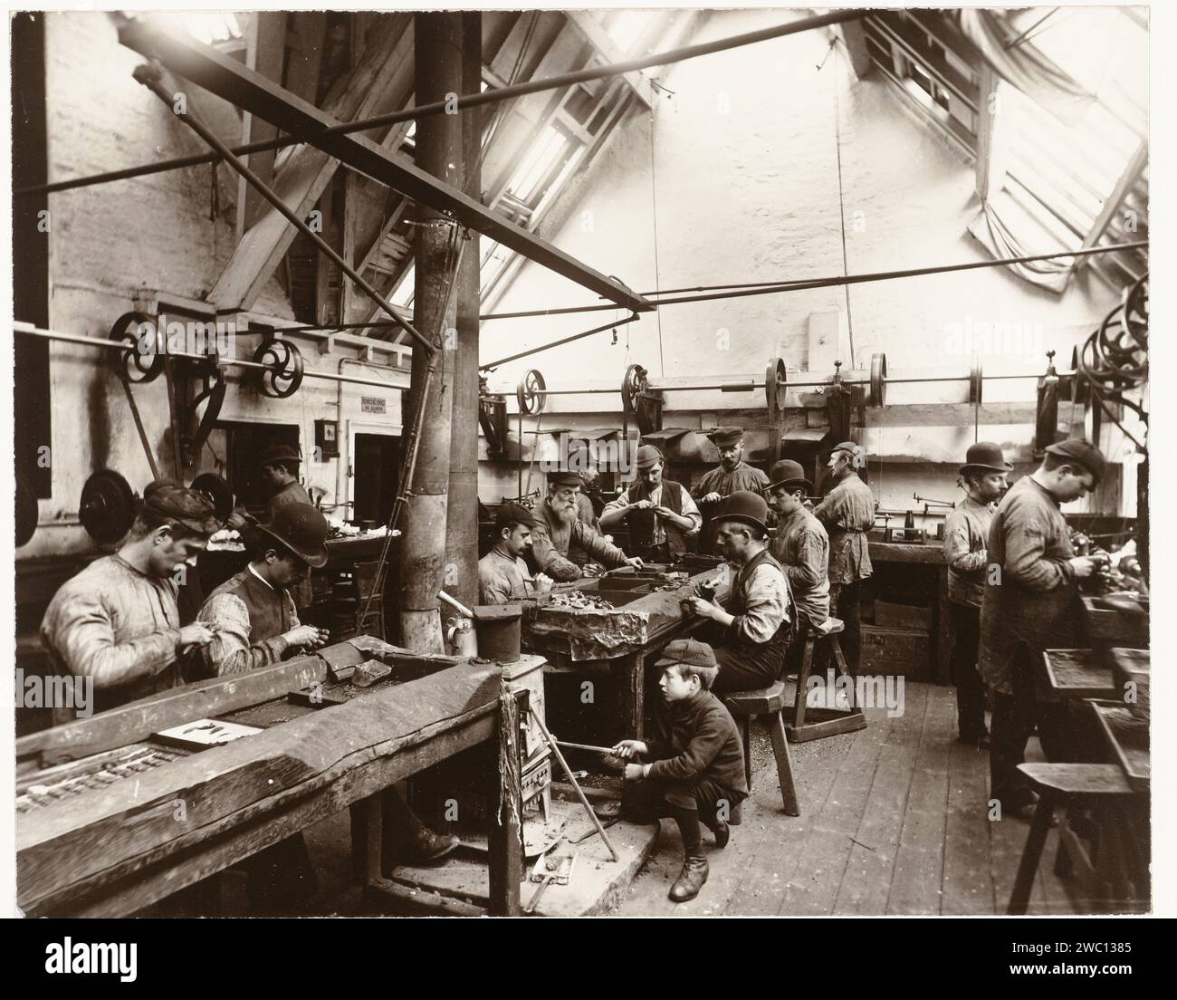 Employees around a workbench in a factory, Frank Meadow Sutcliffe, 1900 ...