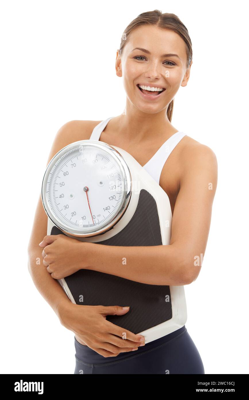 Studio portrait, smile and woman with scale to track weight loss ...