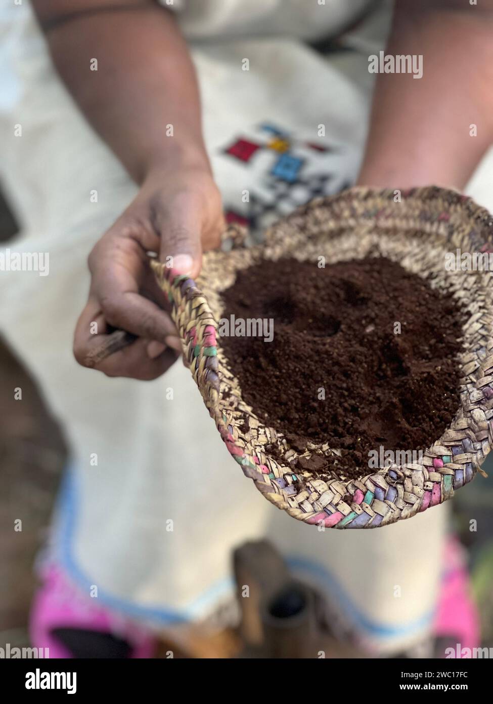 hand-ground coffee beans presented in a wicker basket and carried by ...