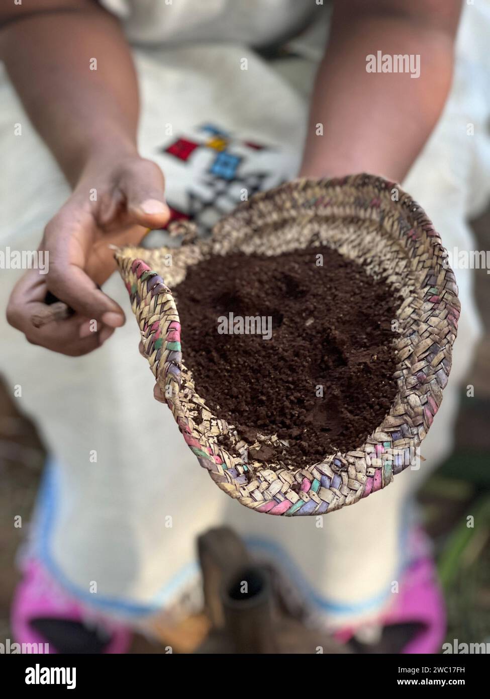 hand-ground coffee beans presented in a wicker basket and carried by ...