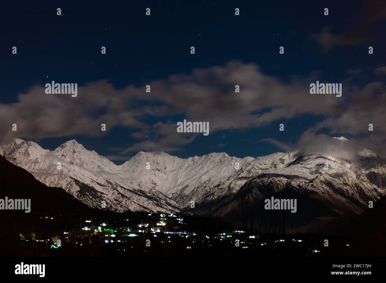 night landscape of snow mountains lights and trees , snow capped ...