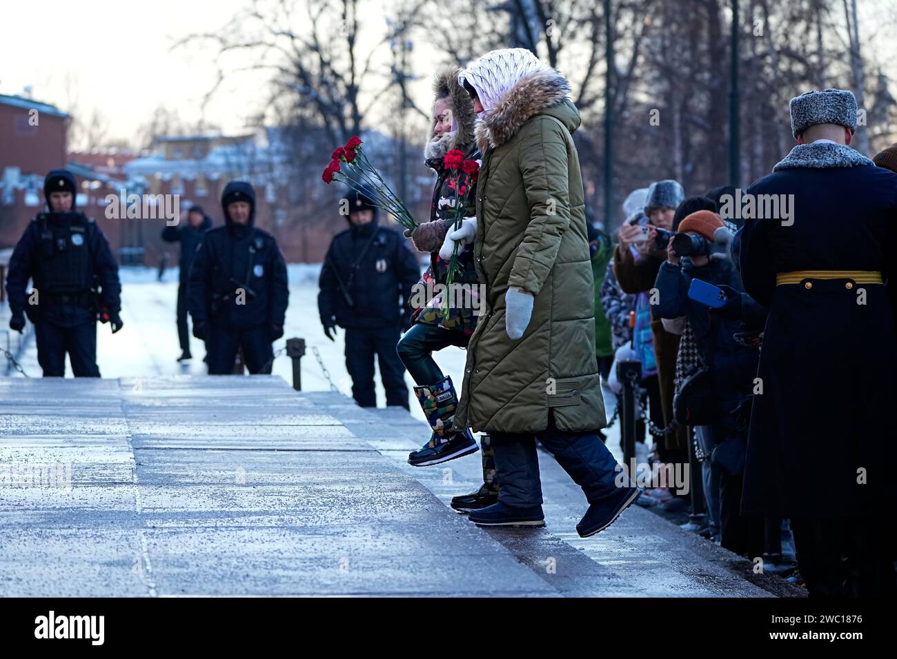 Wives of Russian soldiers mobilized for fighting in Ukraine walk to lay ...