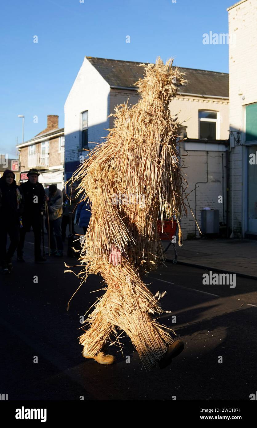 The Straw Bear is paraded through the streets accompanied by attendant ...