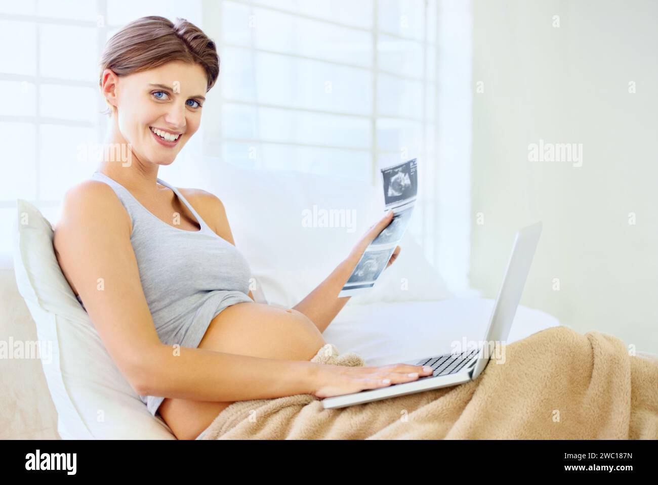 Pregnant woman, portrait and ultrasound with laptop in home, wellness ...