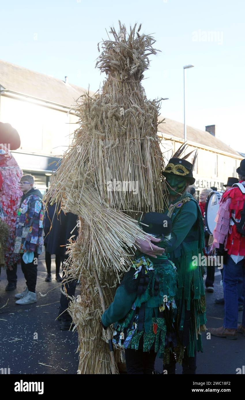 The Straw Bear is paraded through the streets accompanied by attendant ...