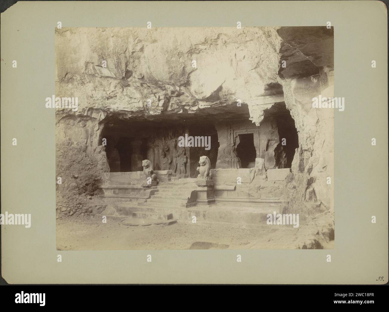 Entrance of a cave temple on Elephanta with lion images and reliefs ...