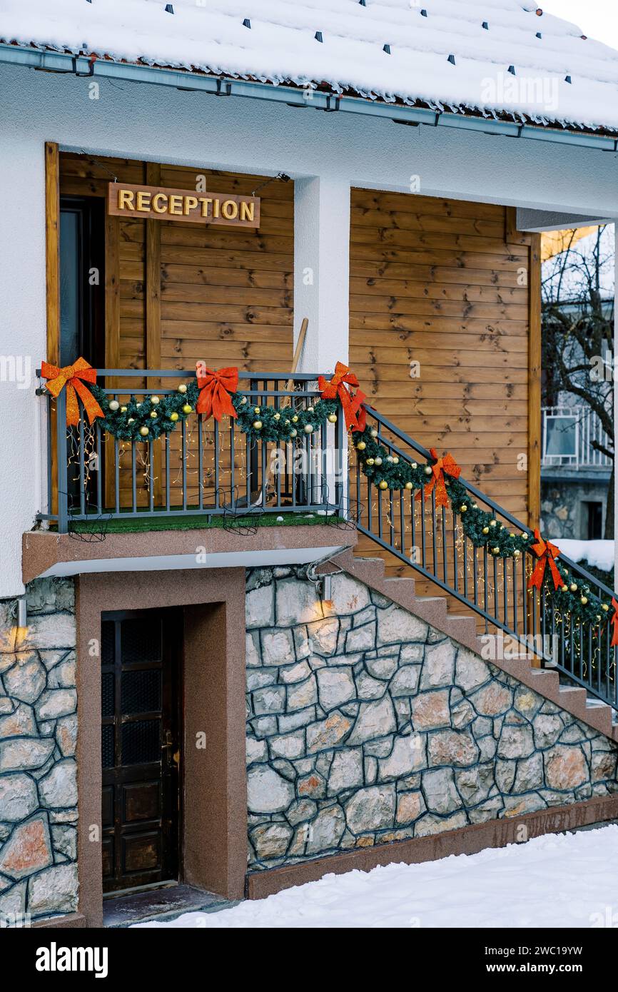 Wrought iron handrails above the stone steps of the hotel are decorated ...
