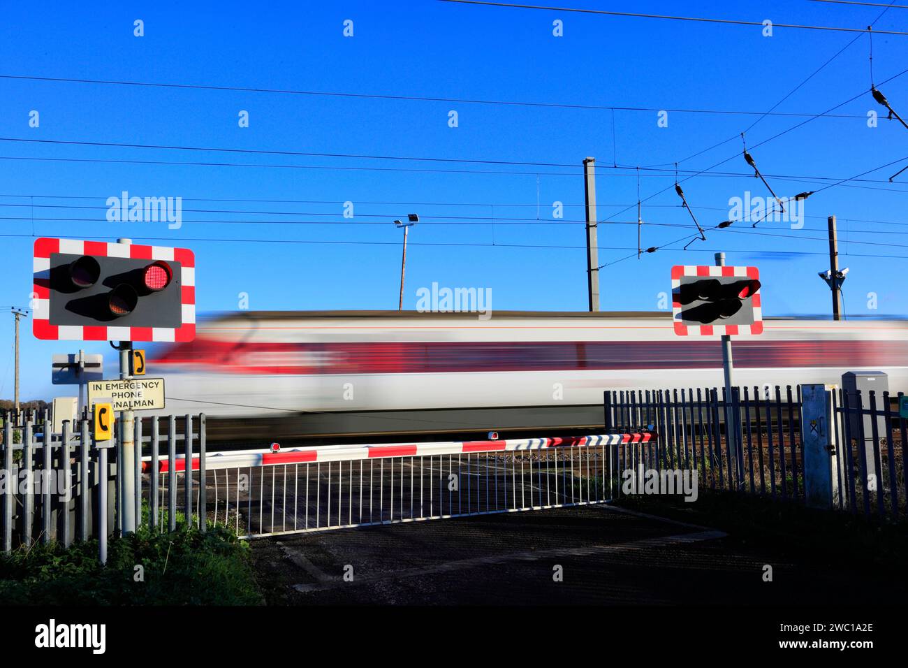 An Azuma train passing red lights at an unmanned Level crossing, East ...