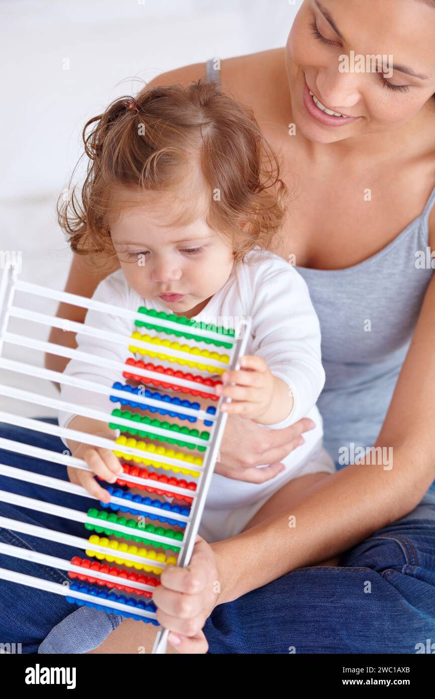 Abacus, education and baby with mother playing, learning and teaching ...