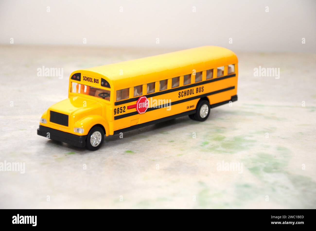 Miniature American school bus in standard yellow color with stop sign ...