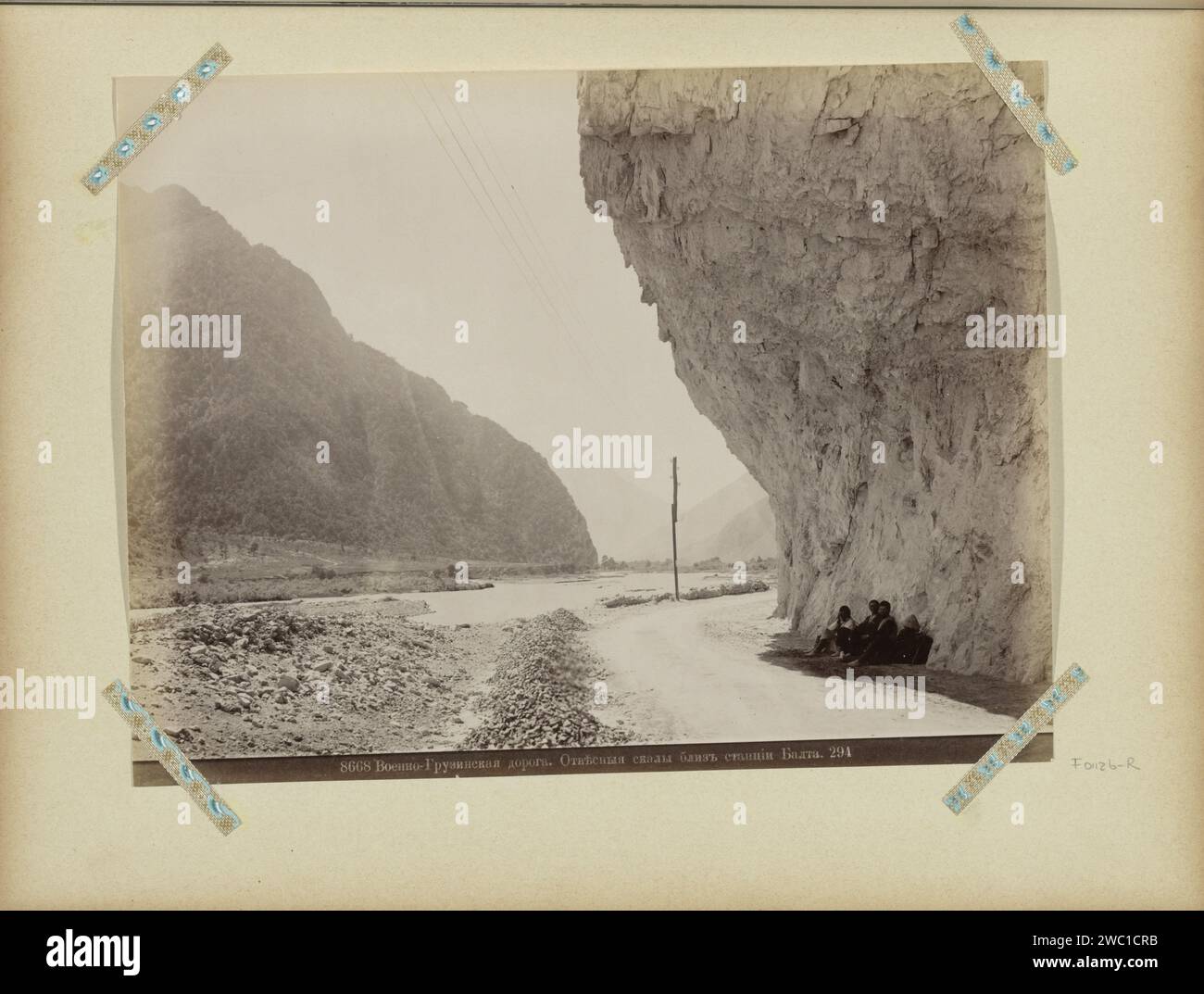 Group men under overhanging rocks on military road at Balta in Georgia ...