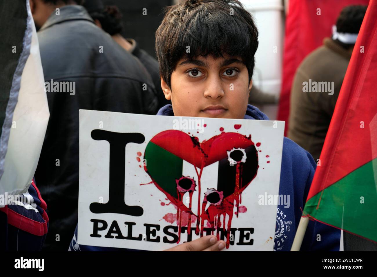 A Pakistani boy holds a placard during a protest against Israeli ...