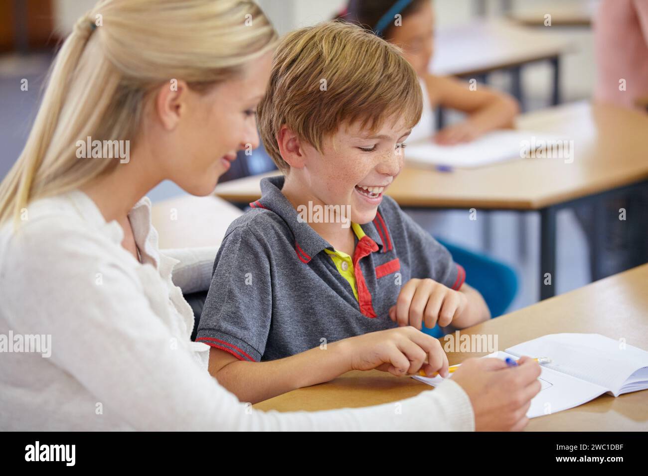 Teacher, children and writing in classroom for learning, education and ...
