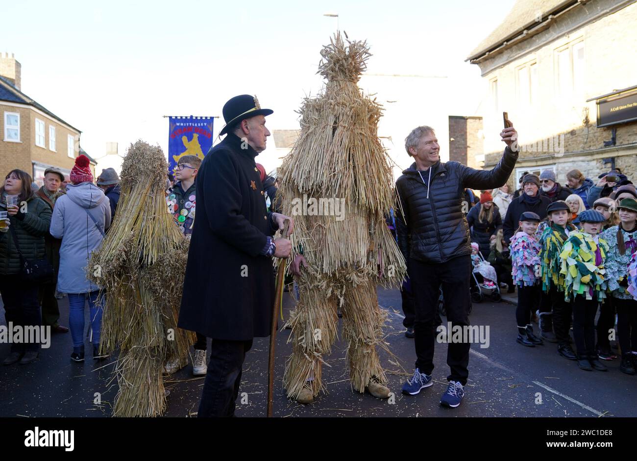 The Straw Bear is paraded through the streets accompanied by attendant ...