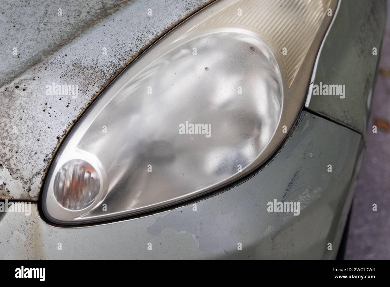 Hazy opaque foggy front head lamp of car reduces light pass-through and ...