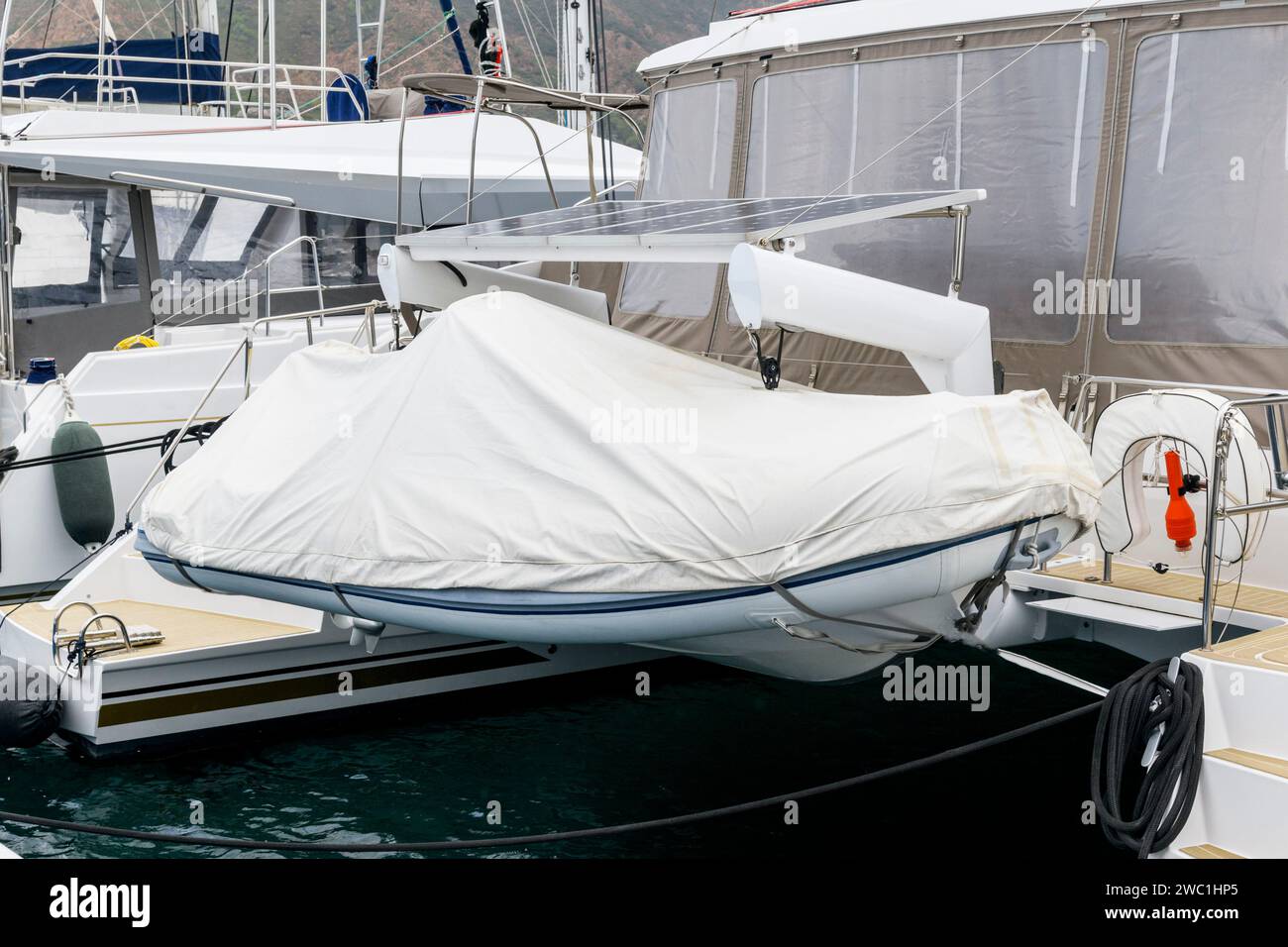 Inflatable tender motor boat on swim platform of superyacht. Inflatable ...