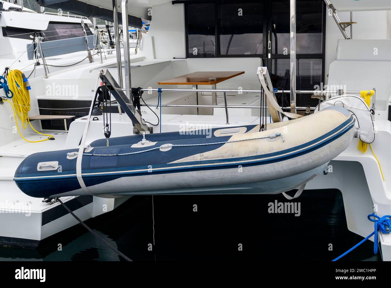 Inflatable tender motor boat on swim platform of superyacht. Inflatable ...