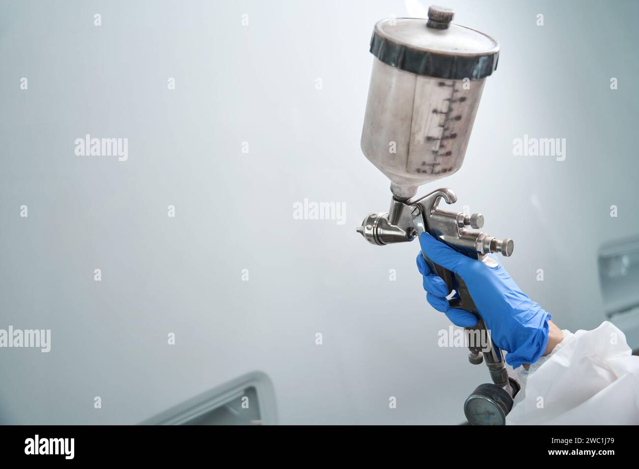 Professional machine for painting car in the hands of master Stock ...