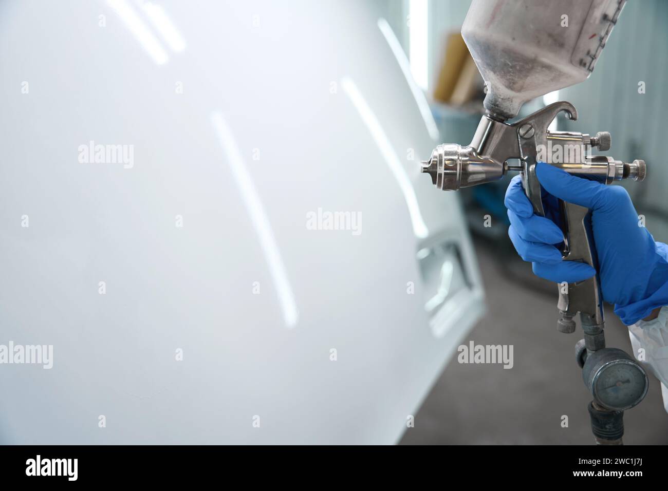 Modern apparatus for painting a car in hands of master Stock Photo - Alamy