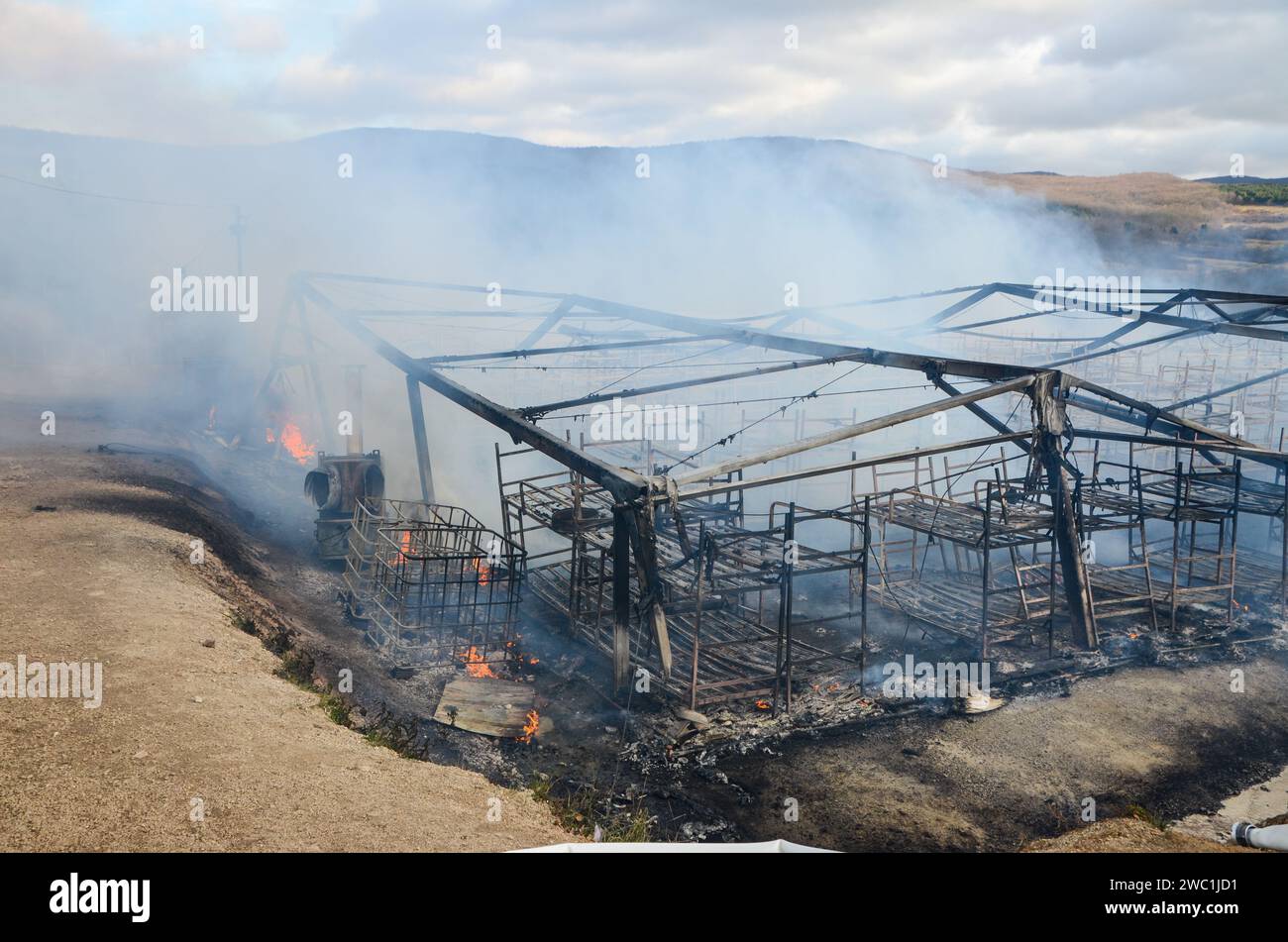 Smoke from a burning building. A large fire destroyed object. Burned ...
