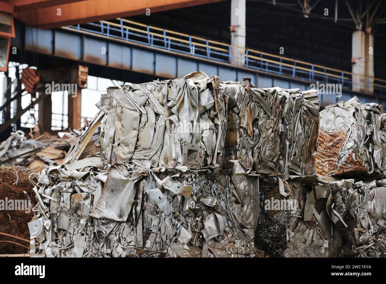 Scrap metal warehouse, pressing non-ferrous metal scrap into cubes ...