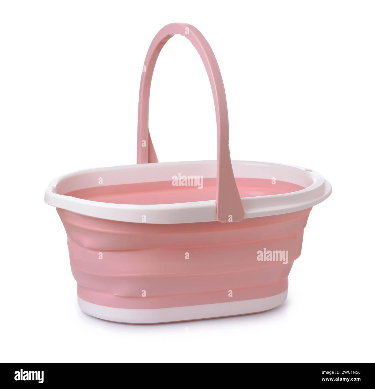 Empty pink collapsible silicone bucket with handle isolated on white ...