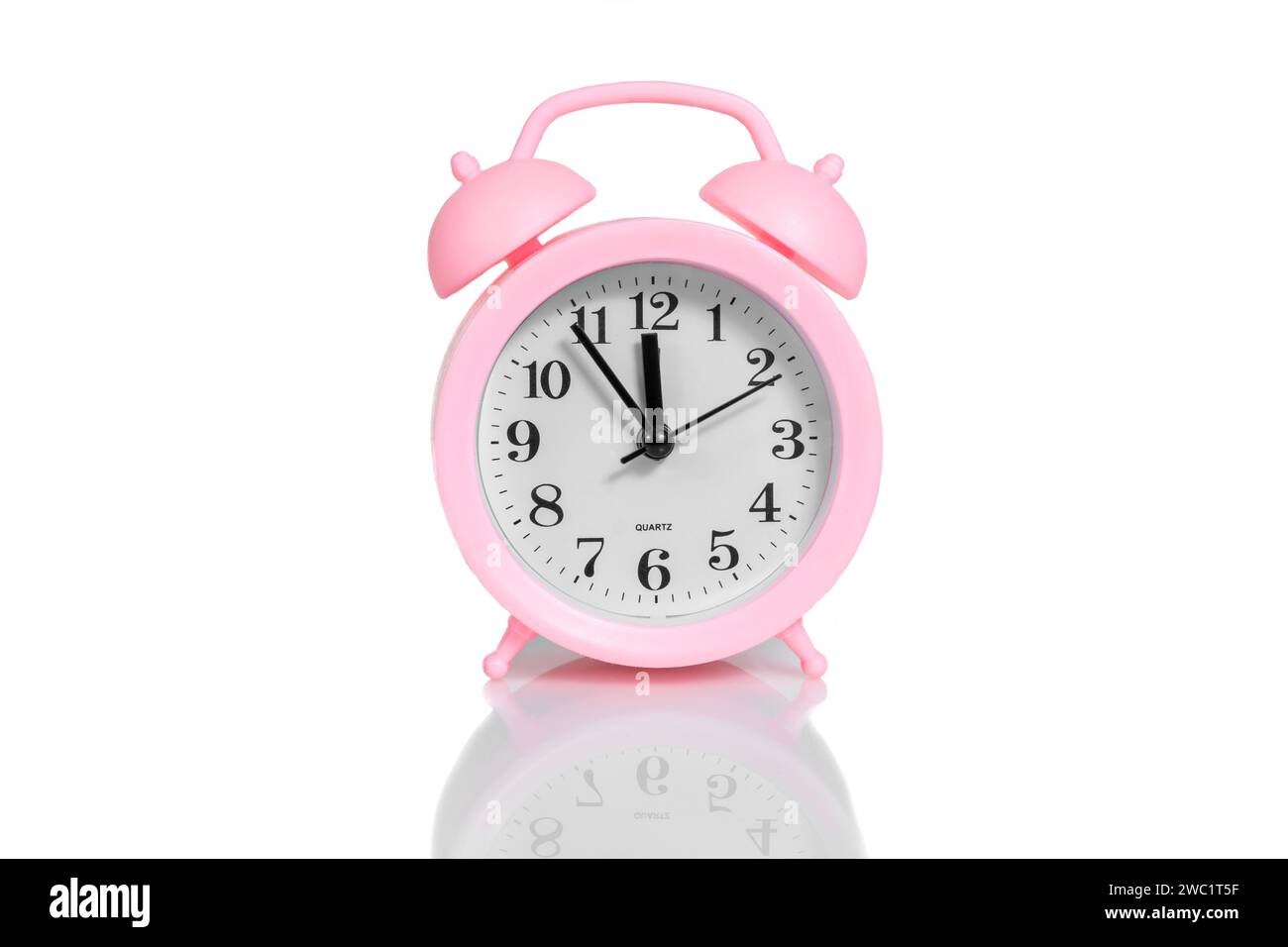 pink alarm clock set twelve o'clock isolated over white background ...