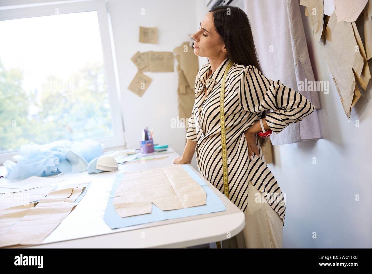 Pregnant woman using measuring tape hi-res stock photography and images ...