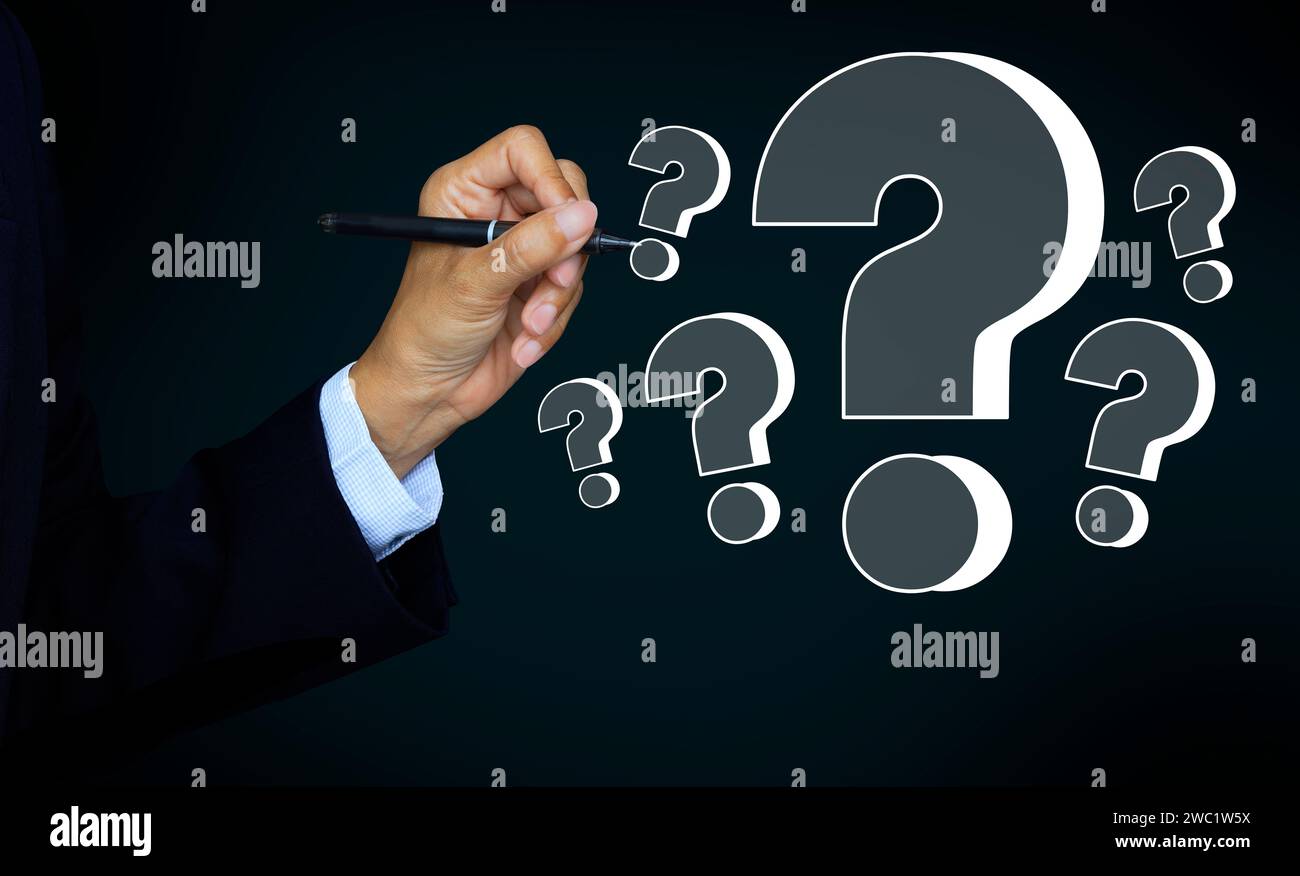 Businessman drawing question marks with a pen Stock Photo - Alamy