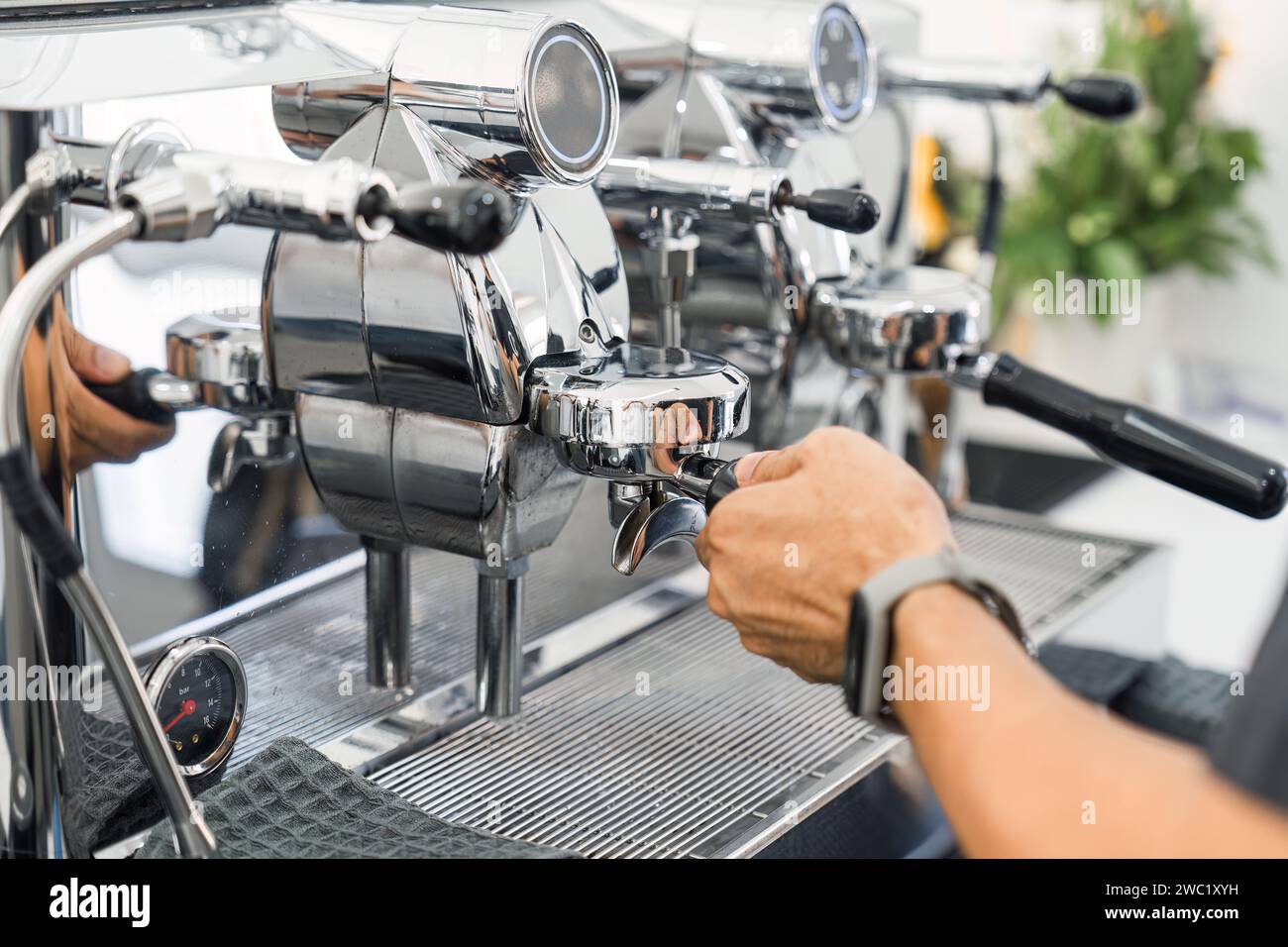 Metallic espresso machine making hot coffee on counter in coffee shop ...