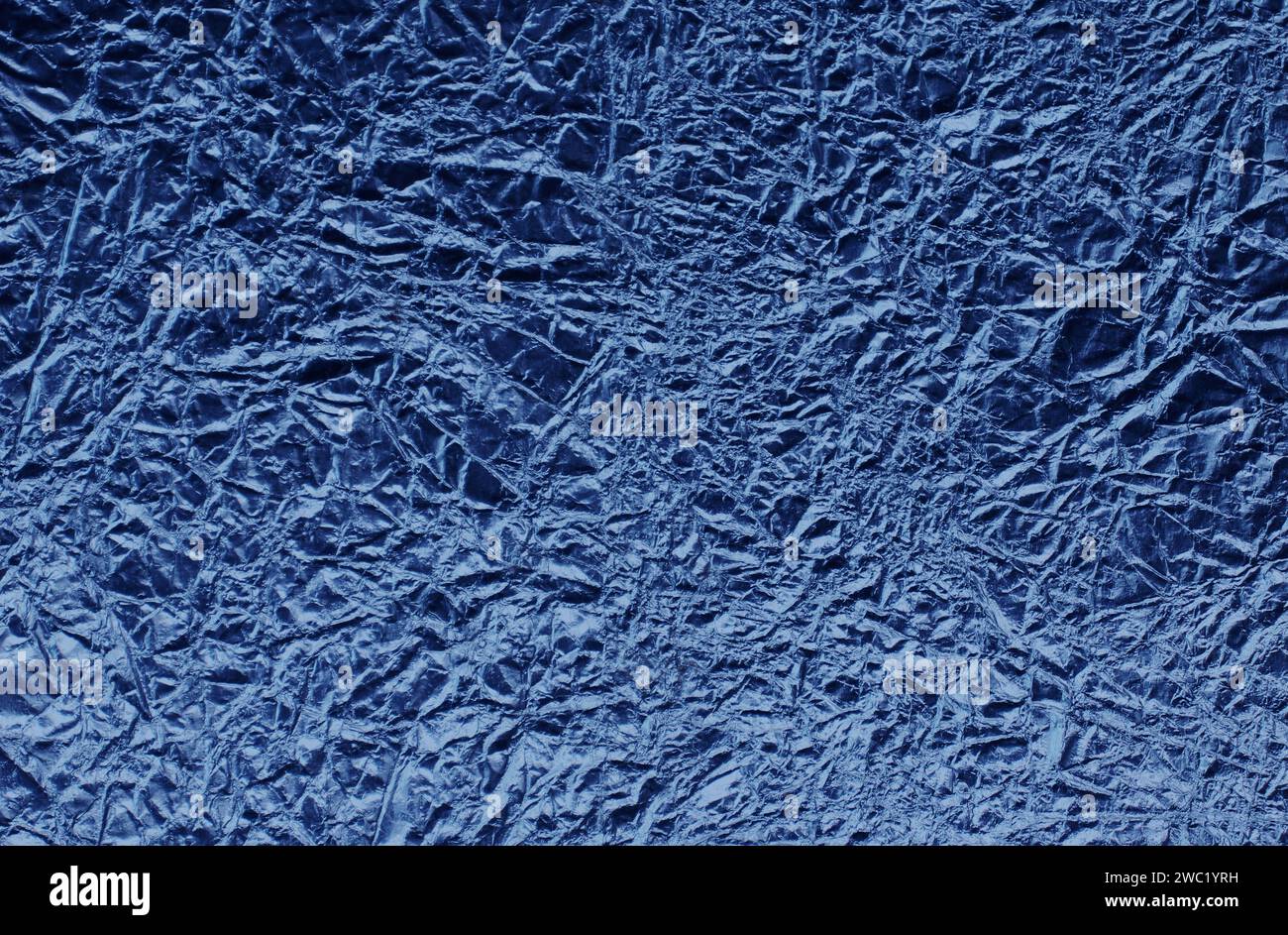 Abstract crumpled blue foil background. Background for design with copy ...
