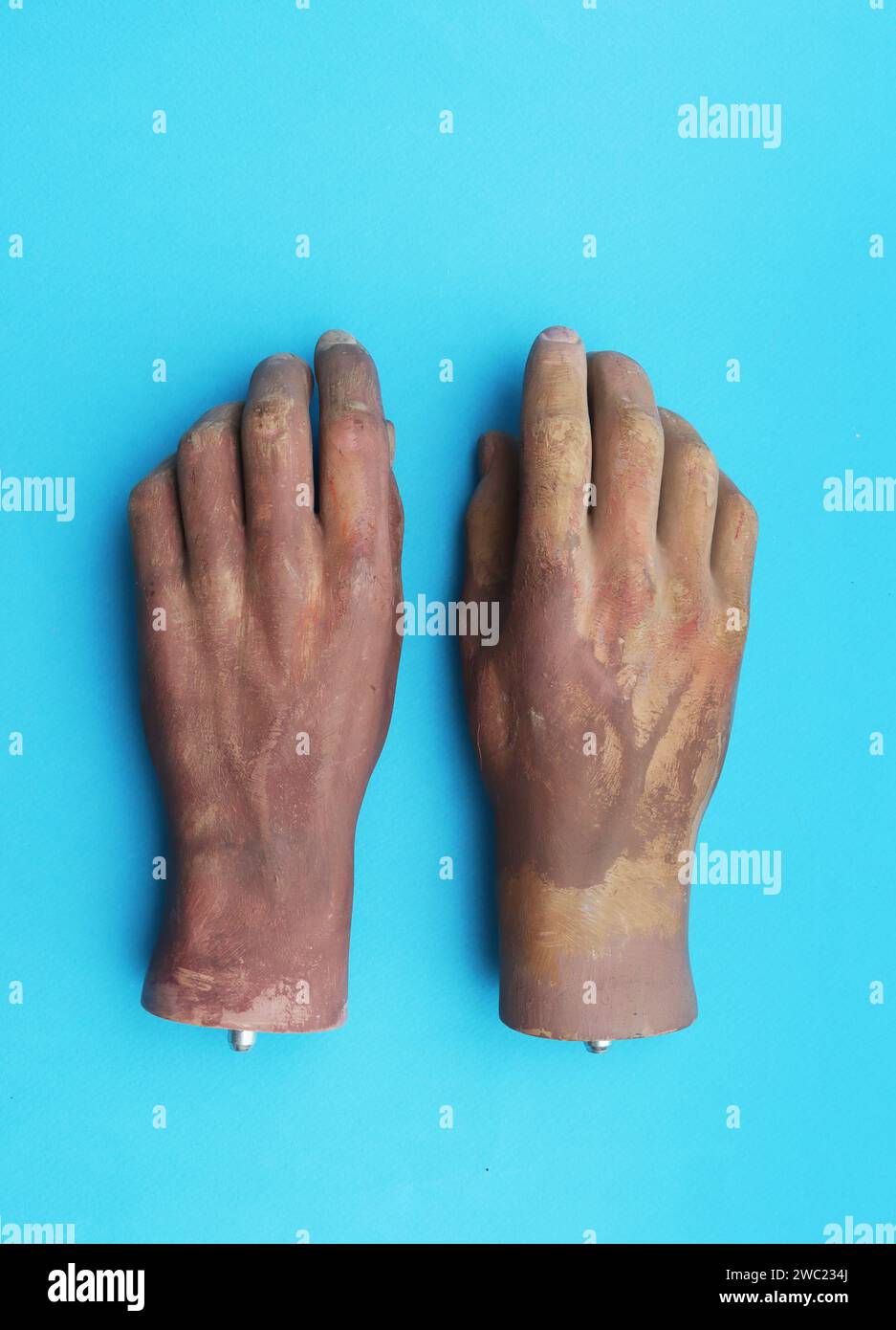 Two wrists from a human hand from a large doll on blue background Stock ...