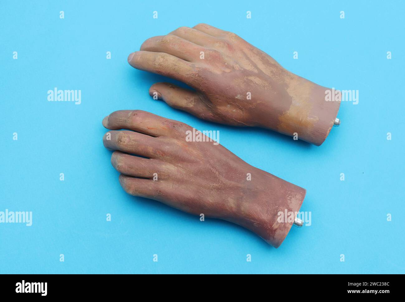 Two wrists from a human hand from a large doll on blue background Stock ...