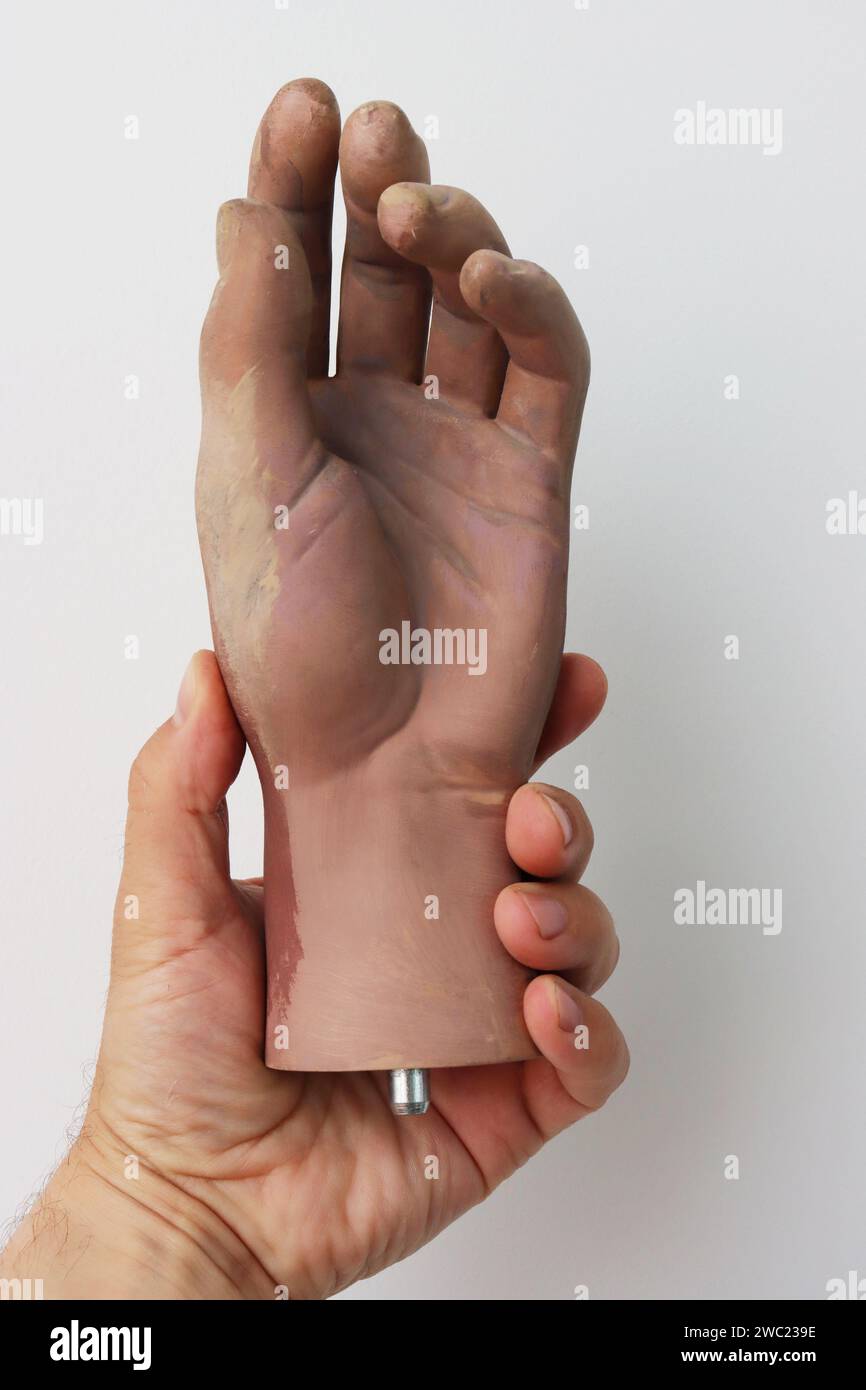Hand holding plastic hand from large doll Stock Photo - Alamy