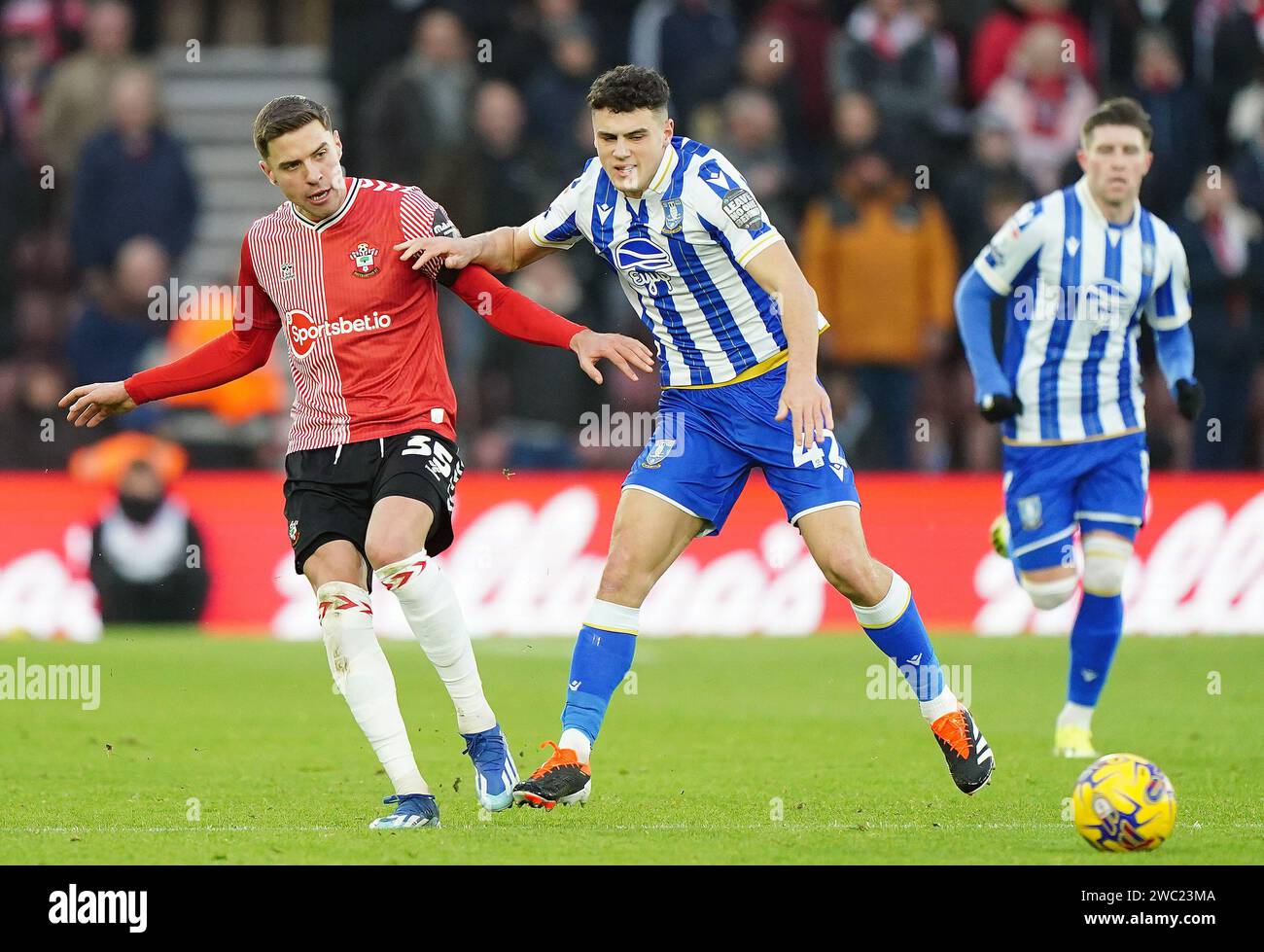 Southampton's Jan Bednarek (left) is challenged by Sheffield Wednesday ...