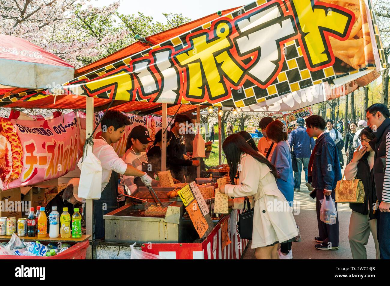 View along fast hot food stall in Osaka Castle Park during the cherry ...