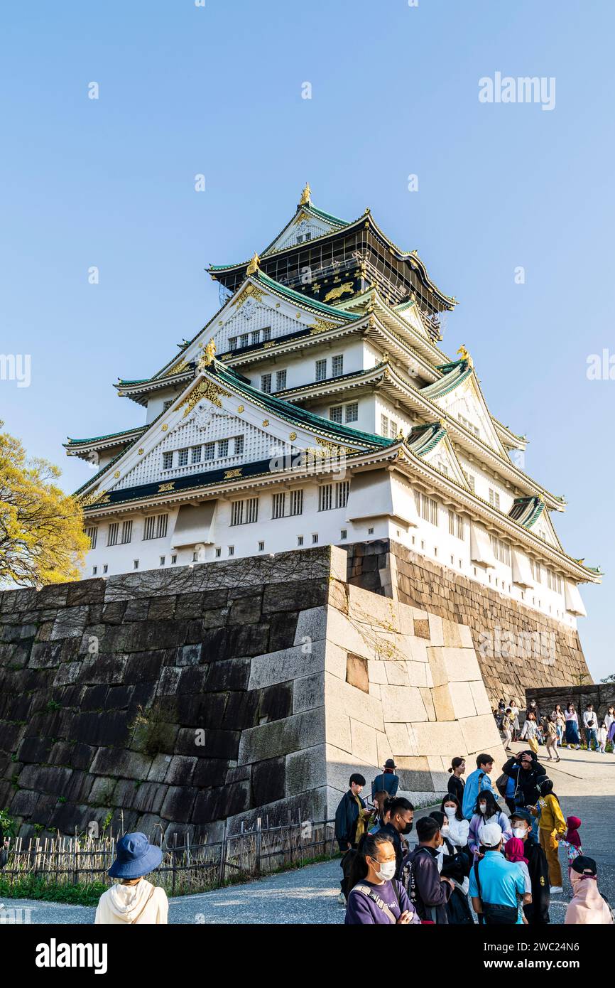 People standing and walking through the foundation of a gate with the ...