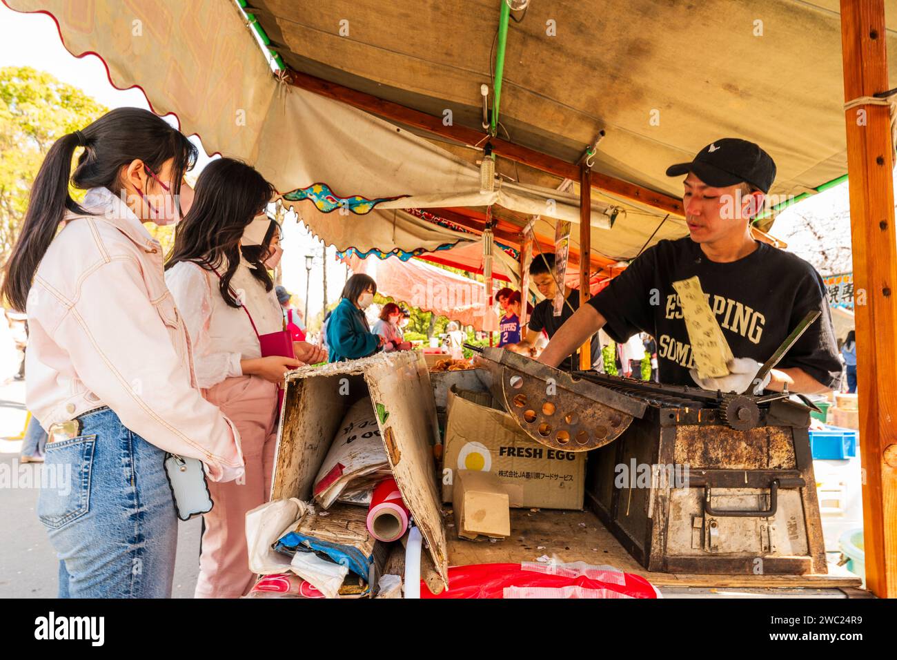 View along food stall in Osaka Castle Park during the cherry blossom ...