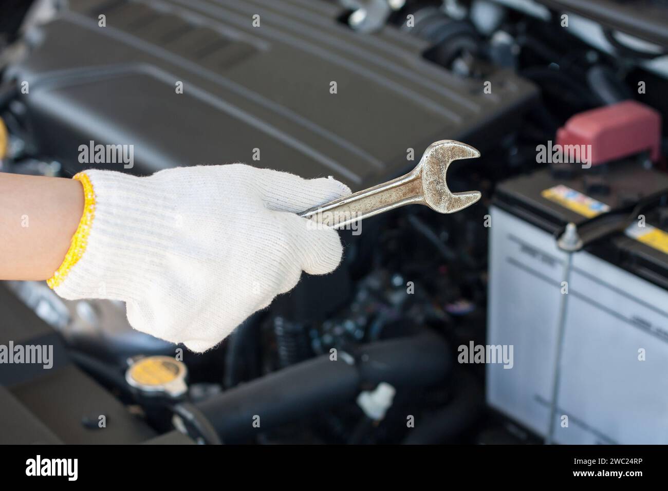 Hand with wrench repairing and checking car engine Stock Photo - Alamy