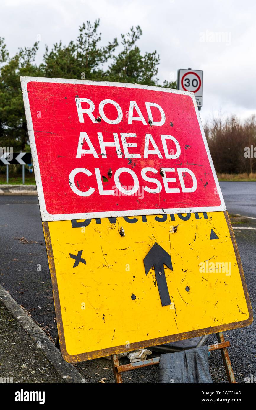 British red 'road ahead closed' sign with another yellow sign ...