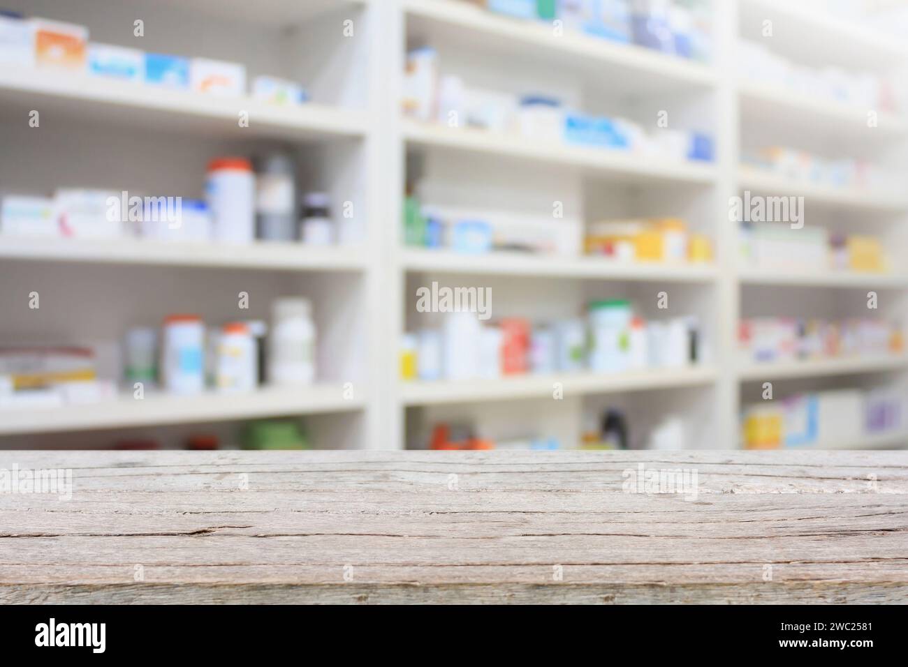 pharmacy product display counter with drugstore shelves background ...