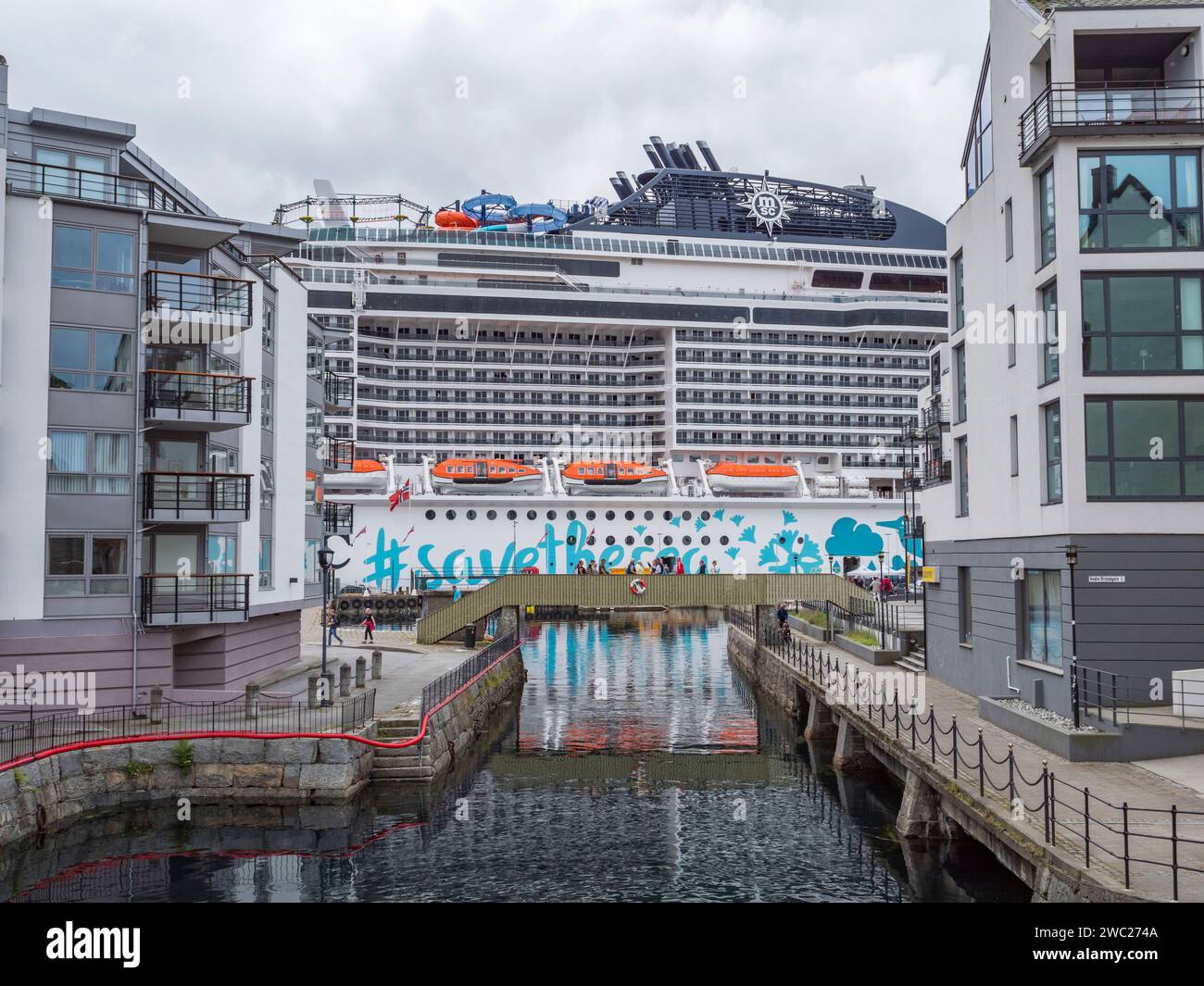 The MSC Euribia cruise ship frmes by buildings at the exit to Alesundet ...