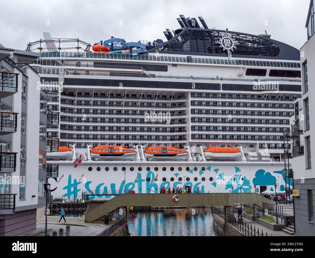 The MSC Euribia cruise ship frmes by buildings at the exit to Alesundet ...