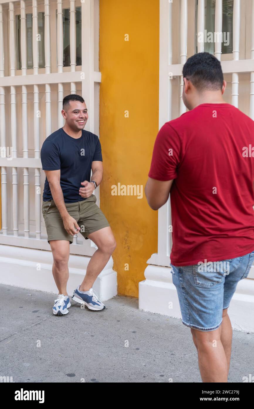 Latin Man Dancing for Smartphone Photo in Urban Setting Stock Photo - Alamy