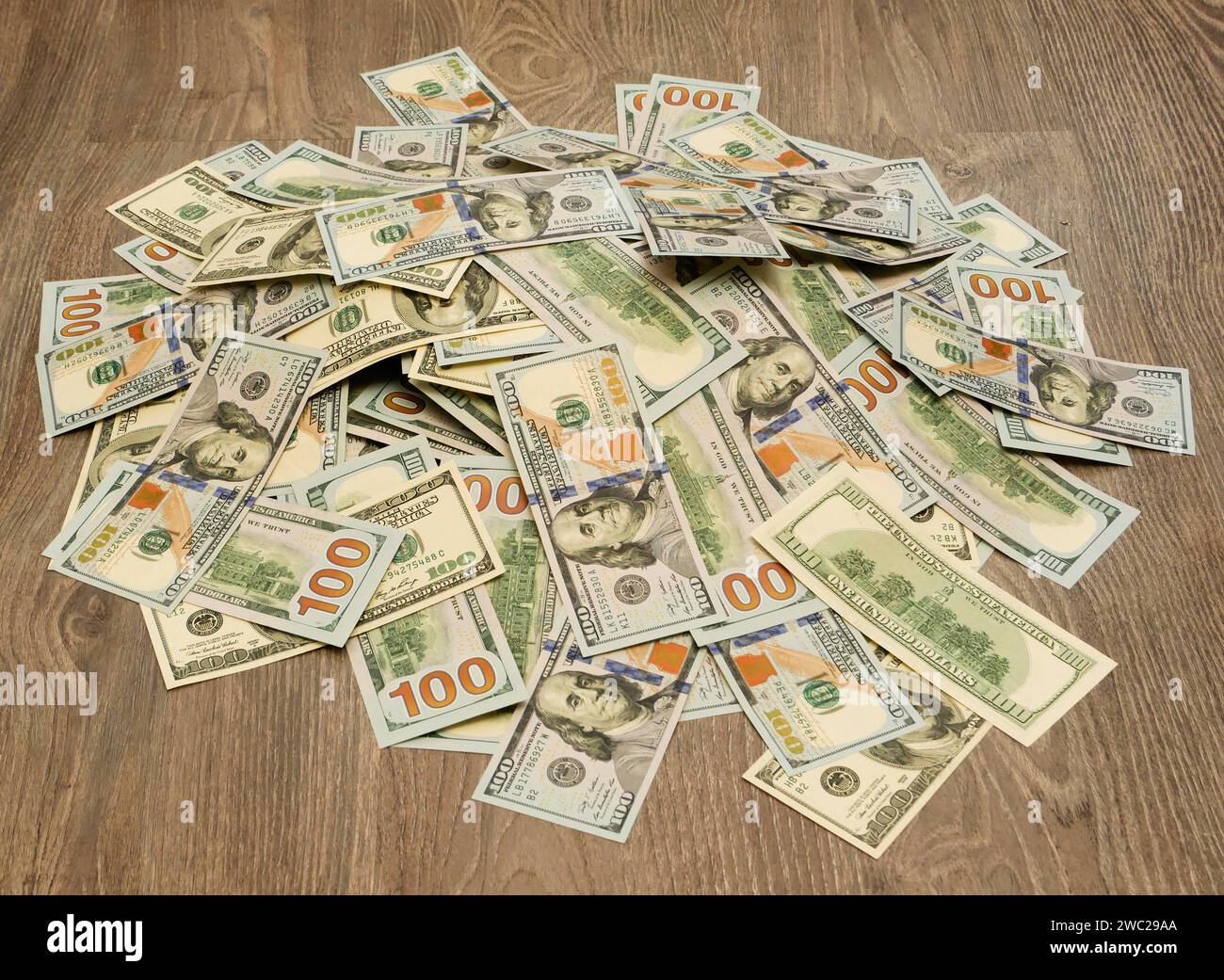 Large pile of hundred dollar bills in background view. Large pile of ...