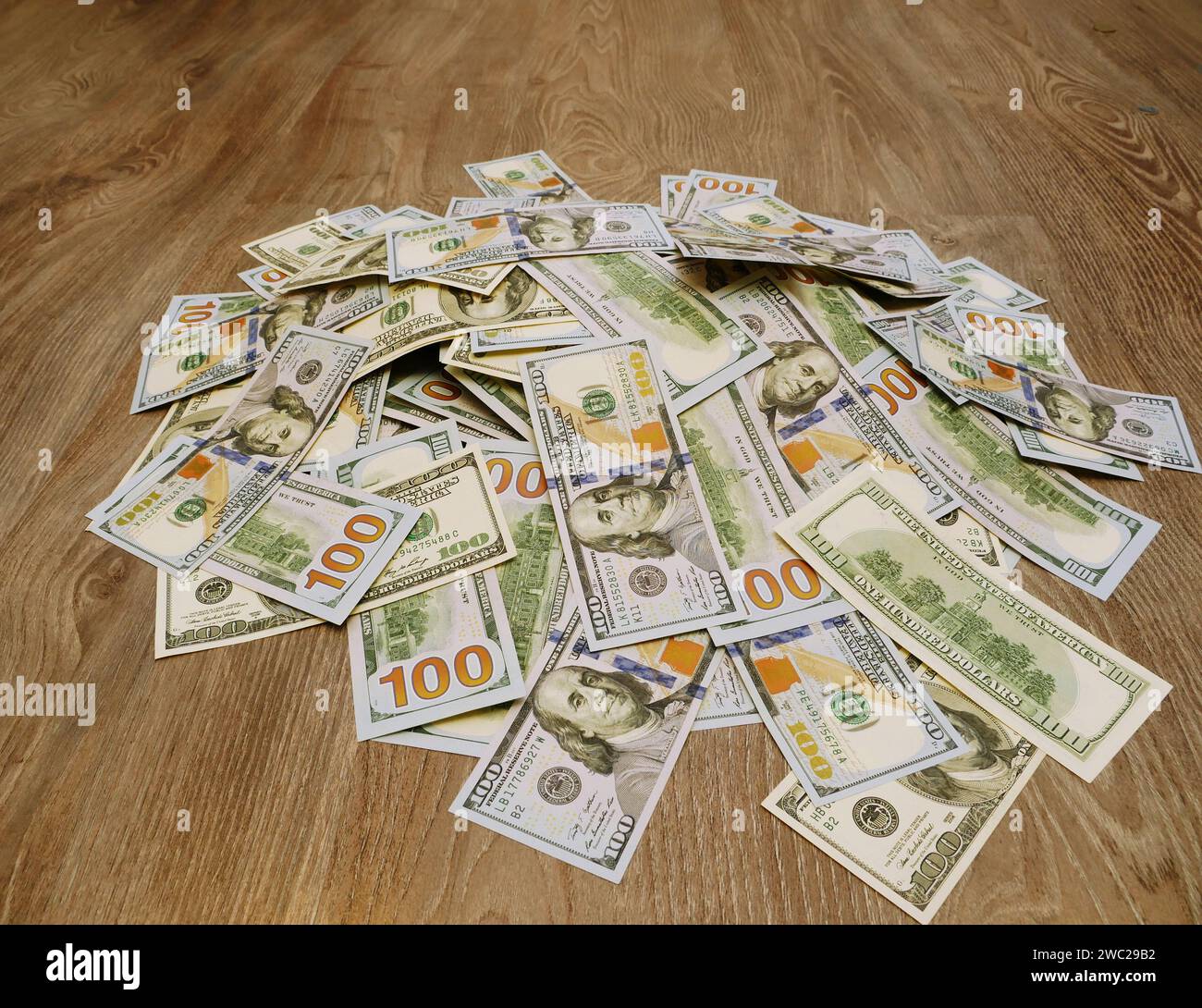 Large pile of hundred dollar bills in background view. Large pile of ...