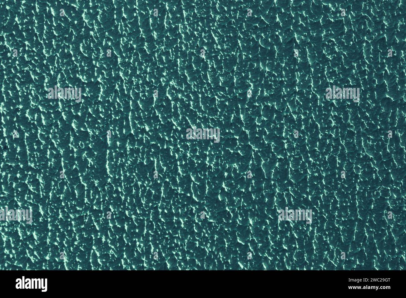 Abstract background from old green plaster. Texturized green putty ...