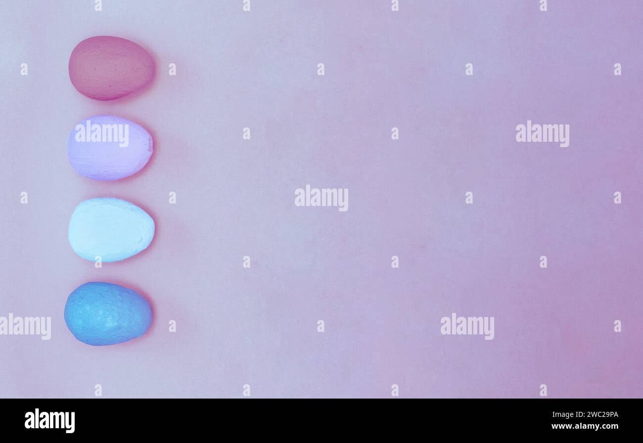 Pink, blue, white and purple homework eggs on uneven magenta paper ...